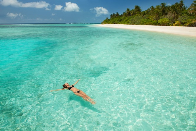 Woman swim and relax in the sea. Happy island lifestyle. White s ...