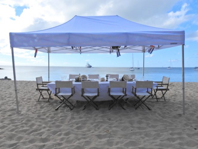 barbecue dining set up on the beach — Yacht Charter & Superyacht News
